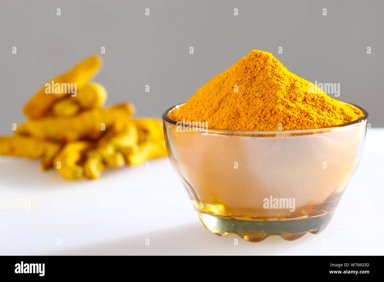 Bowl full of turmeric powder Stock Photo - Alamy