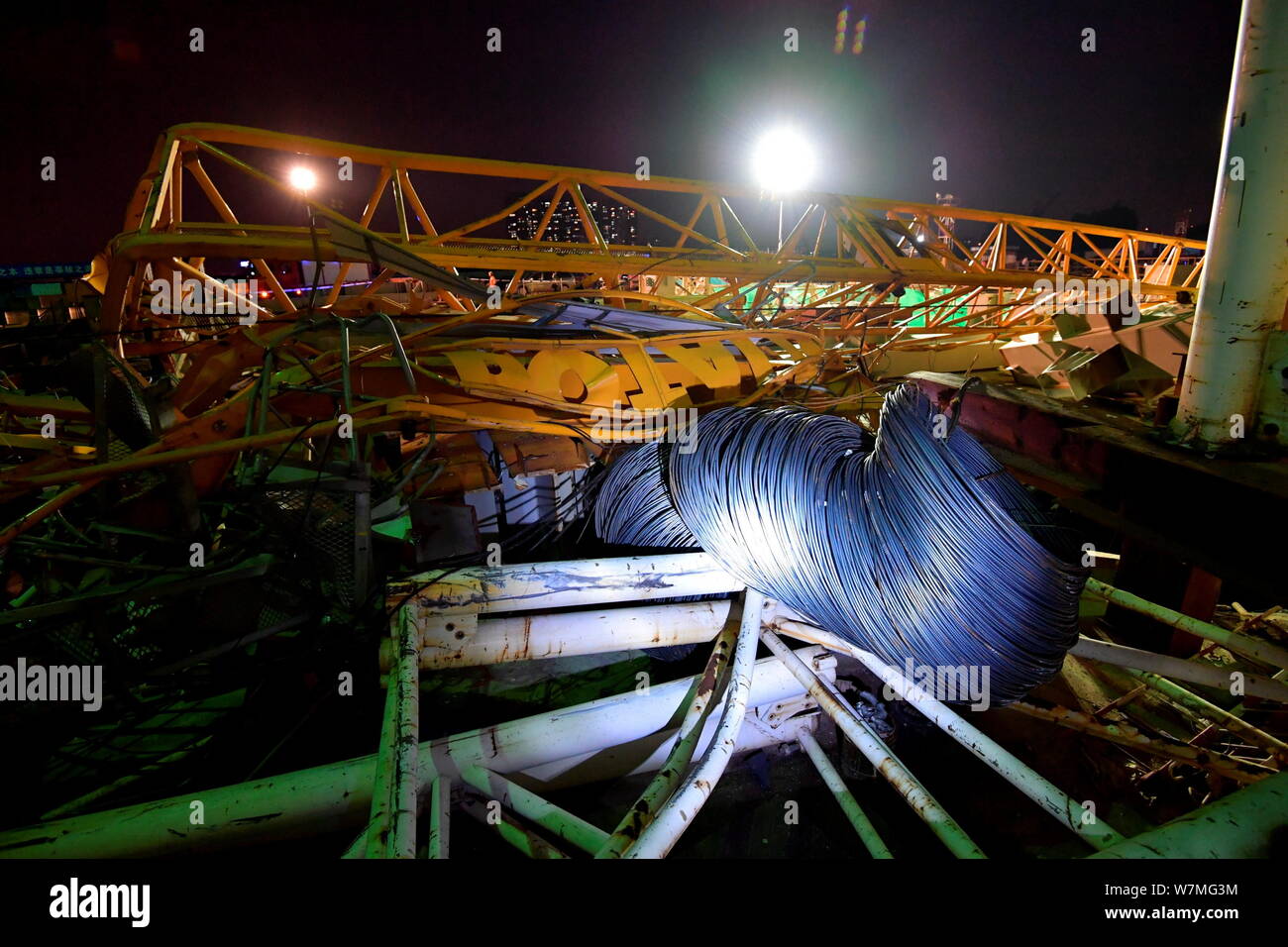 The deformed steel structure of a collapsed tower crane is seen at a ...