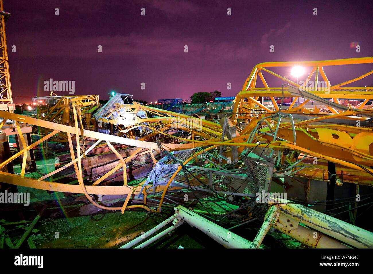 The deformed steel structure of a collapsed tower crane is seen at a ...