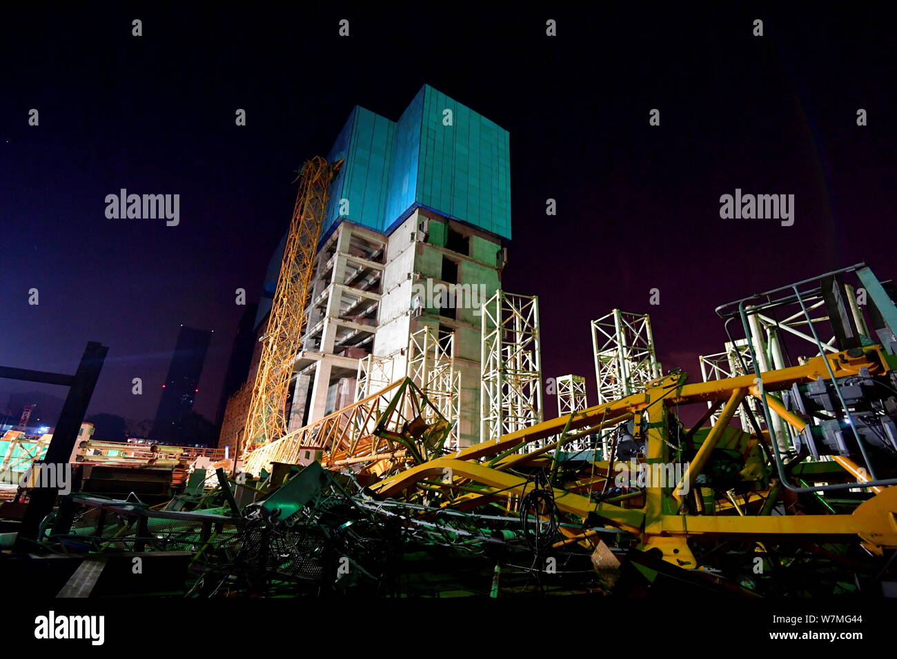 The deformed steel structure of a collapsed tower crane is seen at a ...