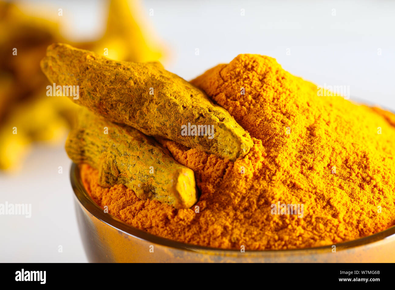 Bowl full of turmeric powder Stock Photo - Alamy