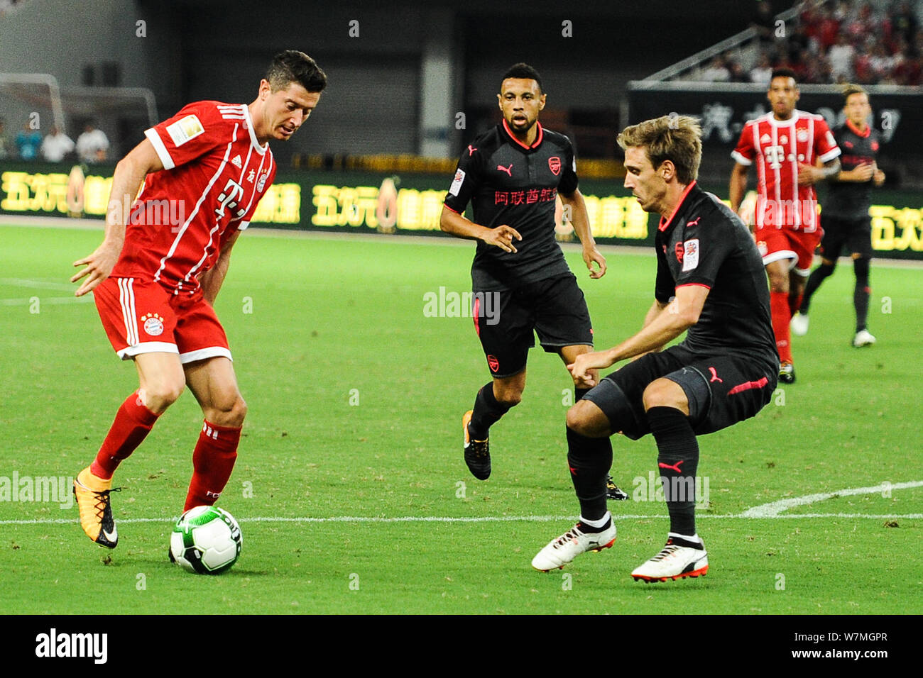Polish football player Robert Lewandowski, left, of Bayern Munich kicks ...