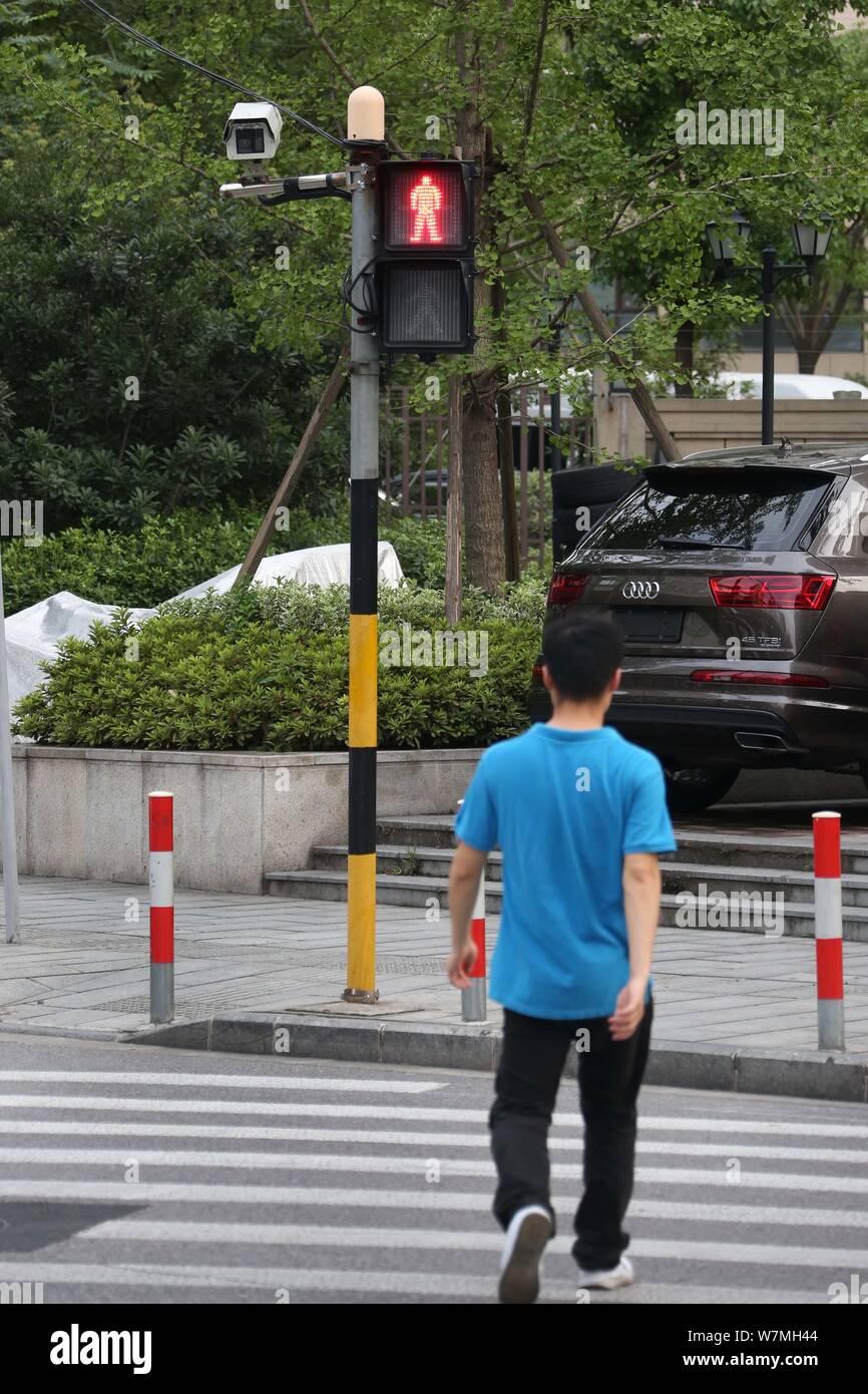 A Chinese man runs red lights in front of a trial electronic police ...