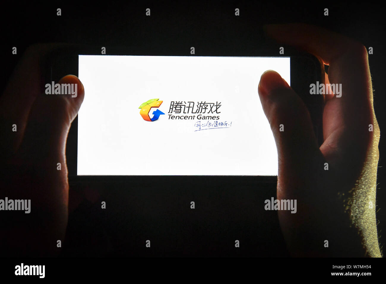 A Chinese mobile game player plays Tencent's mobile MOBA "King of Glory ...