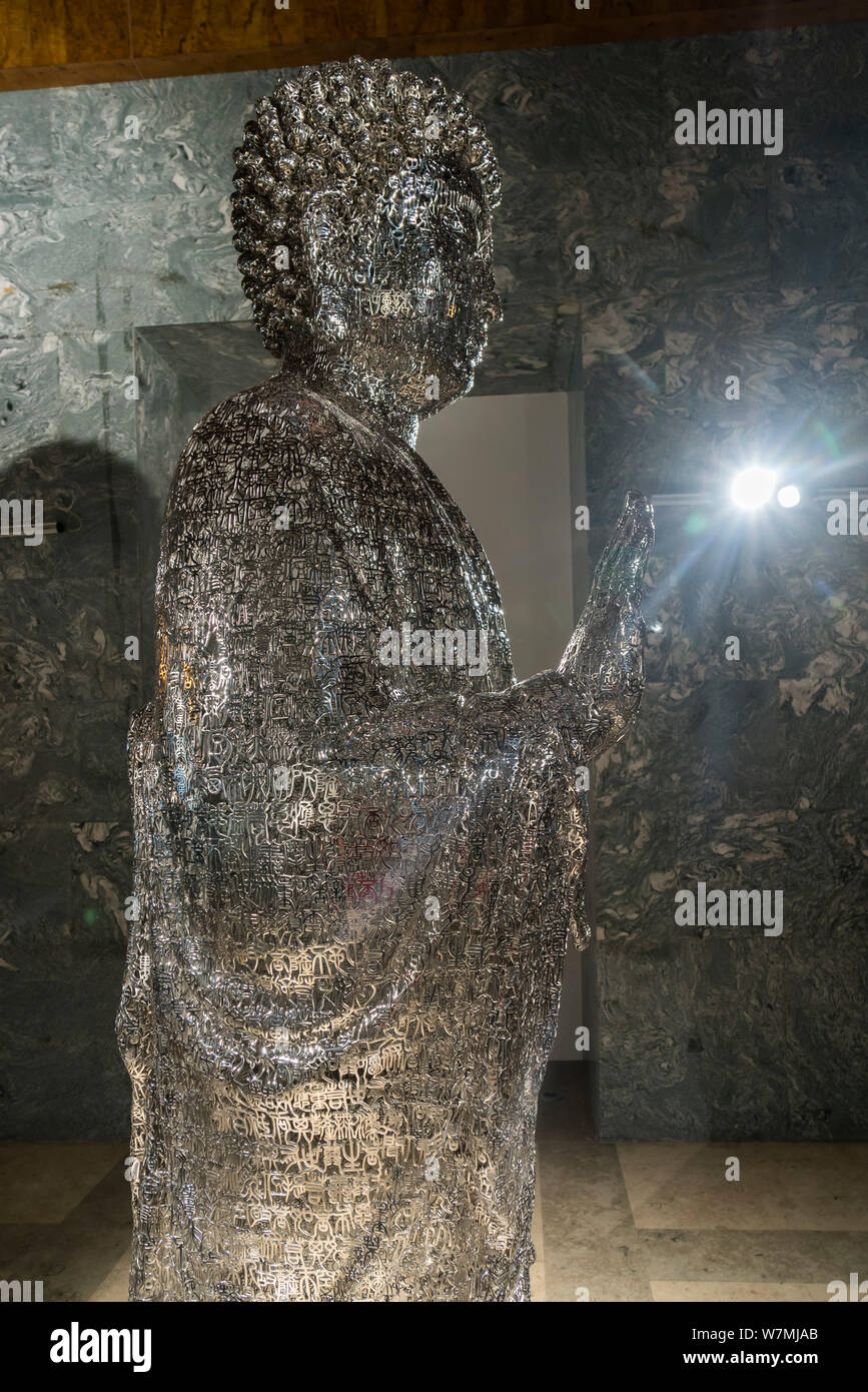 An artwork in the form of a Buddharupa named "Wenyu" is on display at ...