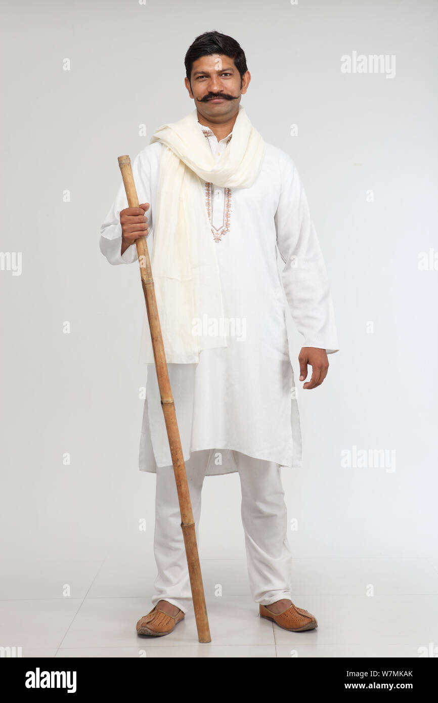Rural man standing with his cane Stock Photo - Alamy