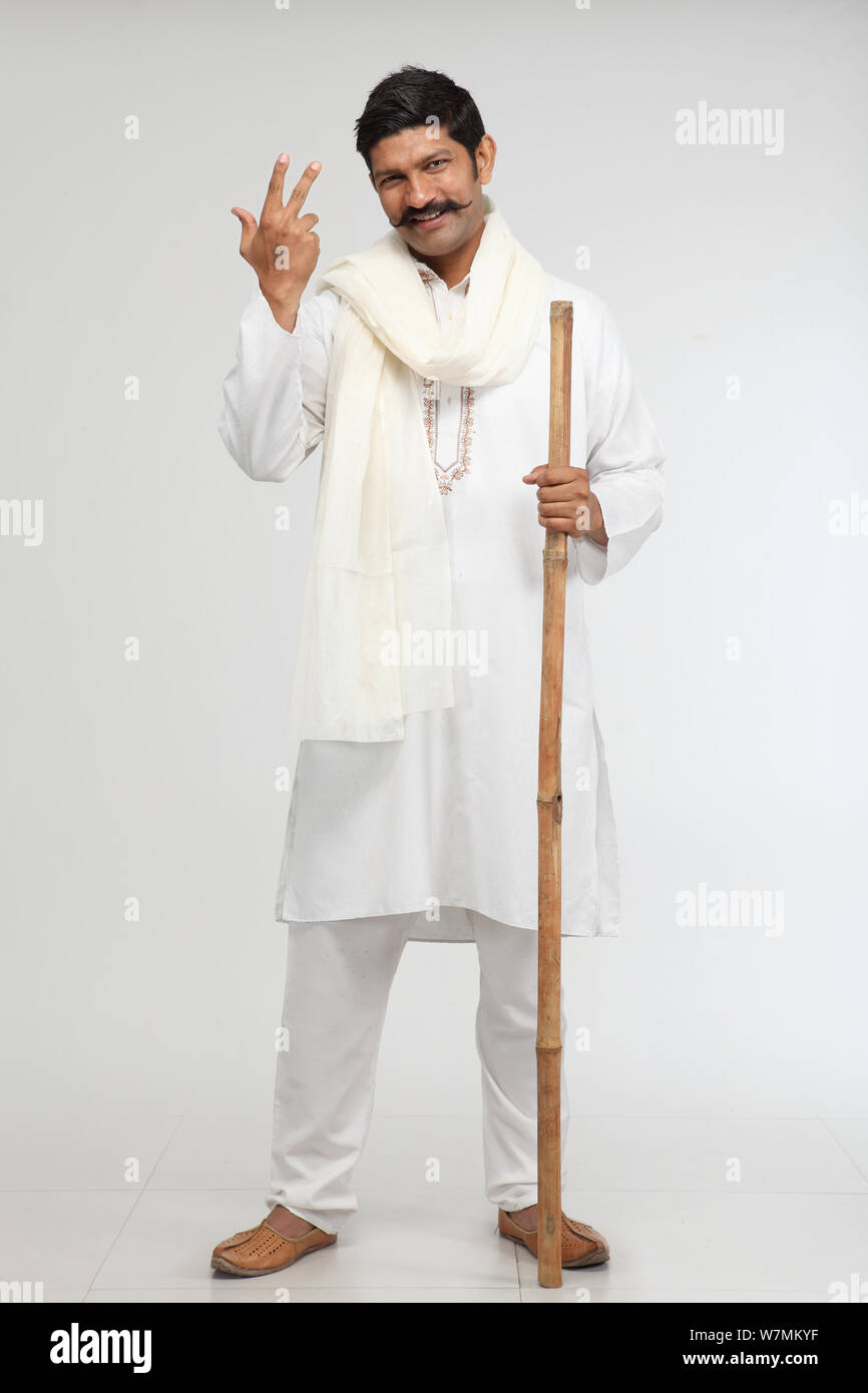 Rural man standing with his cane Stock Photo - Alamy