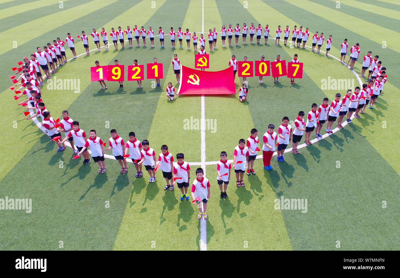 Young students pose for a photo featuring the shape of heart to ...