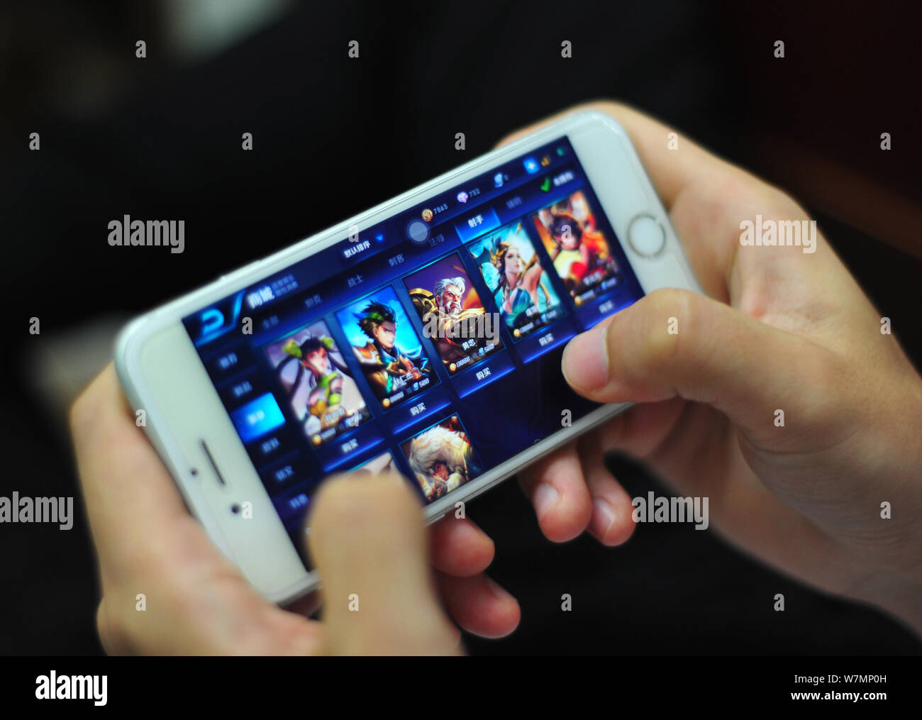 A Chinese mobile game player plays the mobile MOBA "King of Glory" or ...