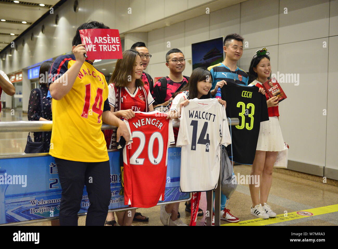 Chinese fans hold banners and jerseys to show support for Arsenal as ...