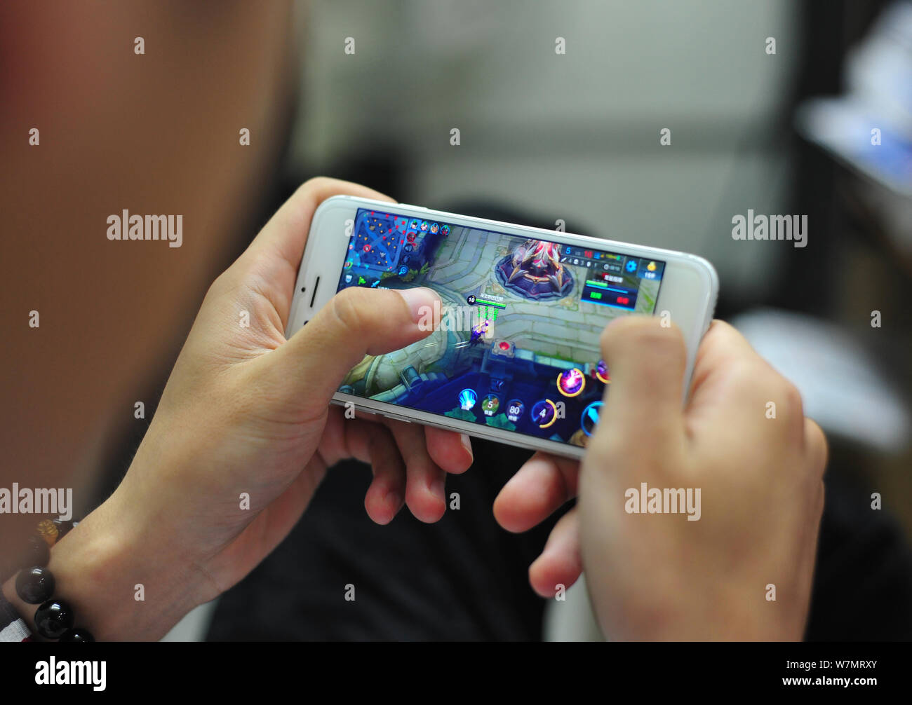 A Chinese mobile game player plays the mobile MOBA "King of Glory" or ...