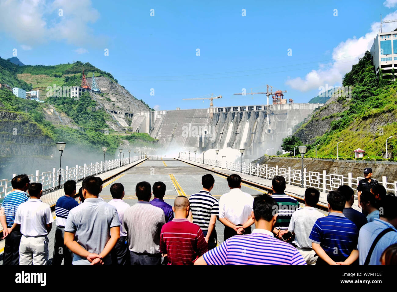 Visitors watch the Longtan hydropower station releasing water for the ...