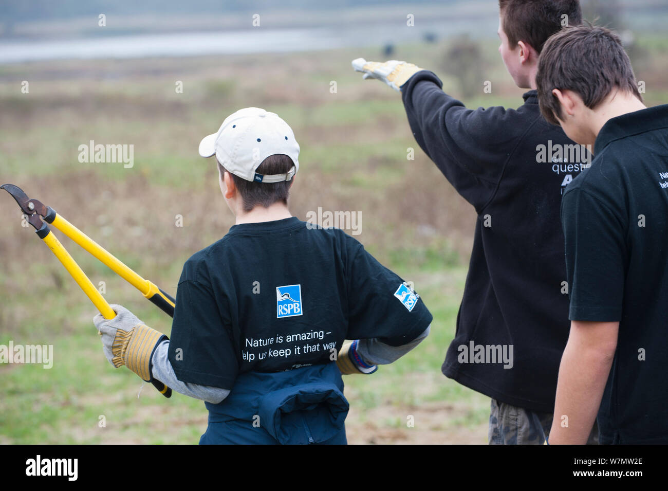 Young volunteers clearing scrub, RSPB Vange Marshes reserve, Basildon ...