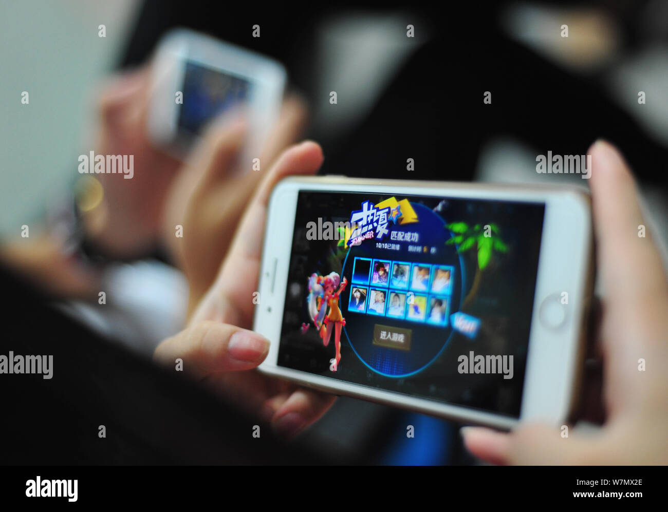 A Chinese mobile game player plays the mobile MOBA "King of Glory" or ...