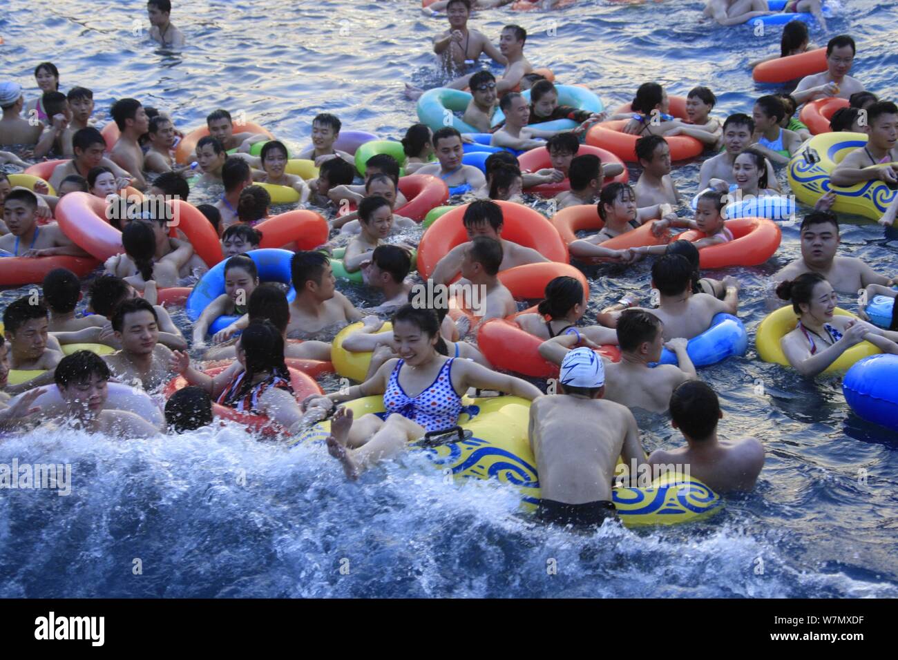 Chinese holidaymakers crowd a swimming pool at a water park in Nanchang ...