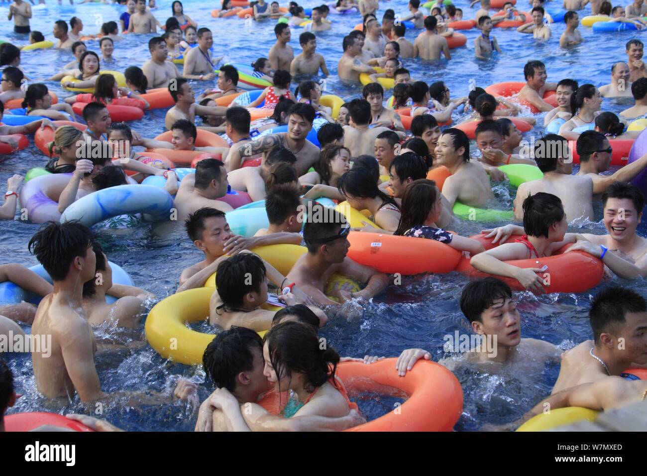 Chinese holidaymakers crowd a swimming pool at a water park in Nanchang ...