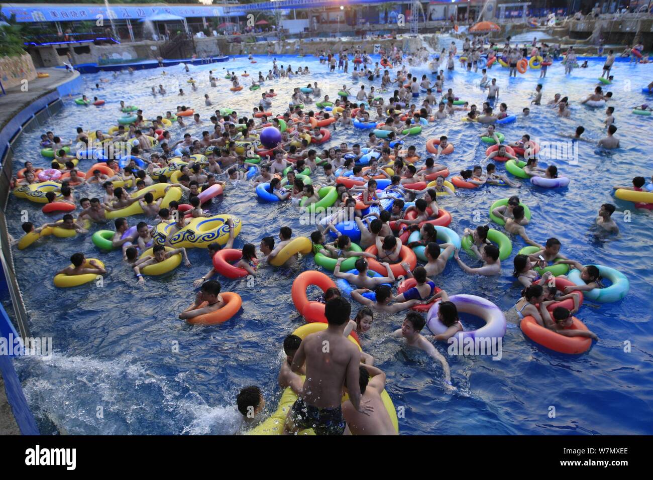 Chinese holidaymakers crowd a swimming pool at a water park in Nanchang ...