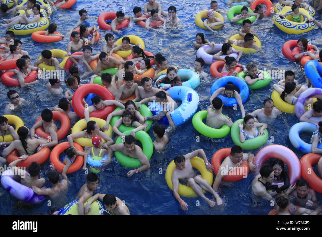 Chinese holidaymakers crowd a swimming pool at a water park in Nanchang ...