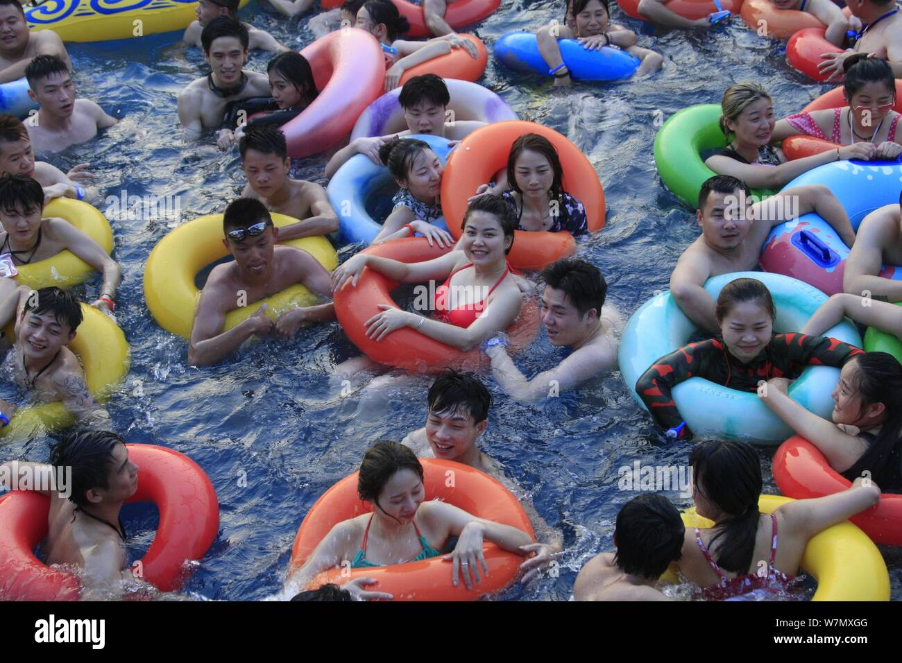 Chinese holidaymakers crowd a swimming pool at a water park in Nanchang ...