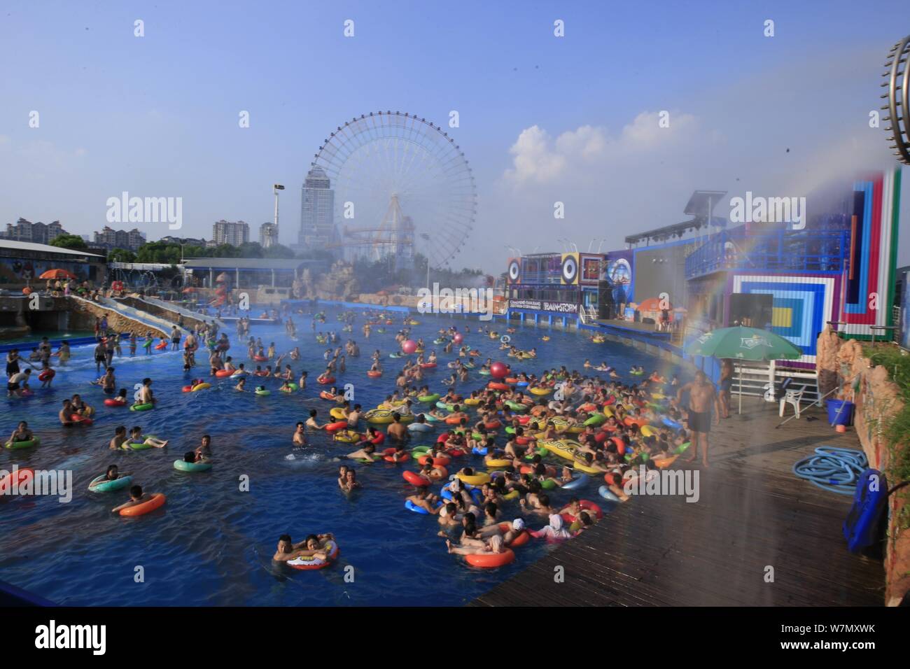 Chinese holidaymakers crowd a swimming pool at a water park in Nanchang ...