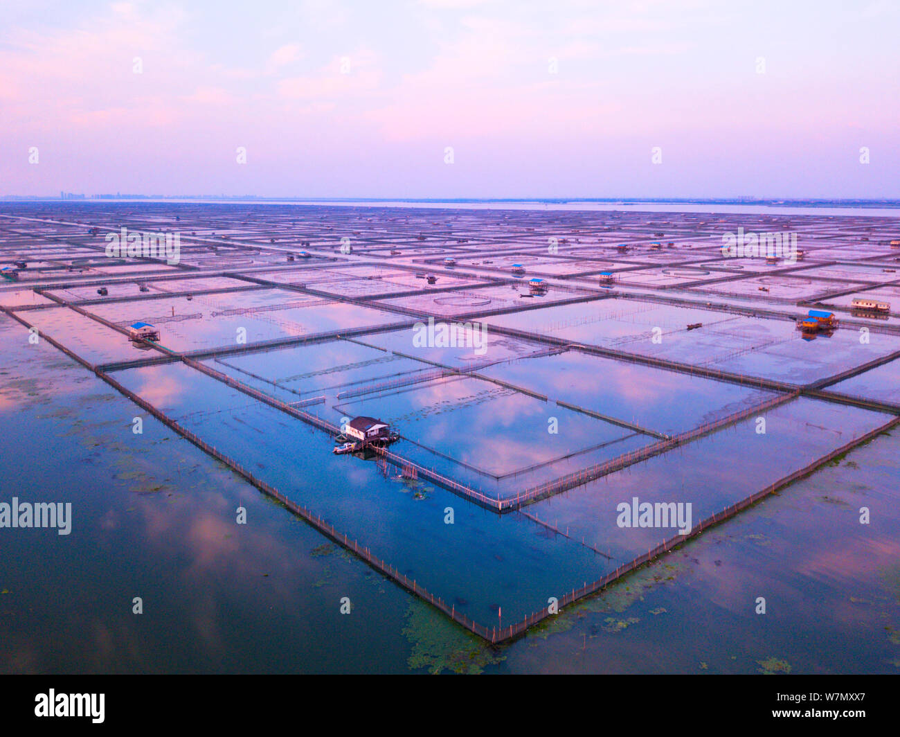 Scenery of flaming cloud over fish ponds of Taihu Lake in Suzhou city ...
