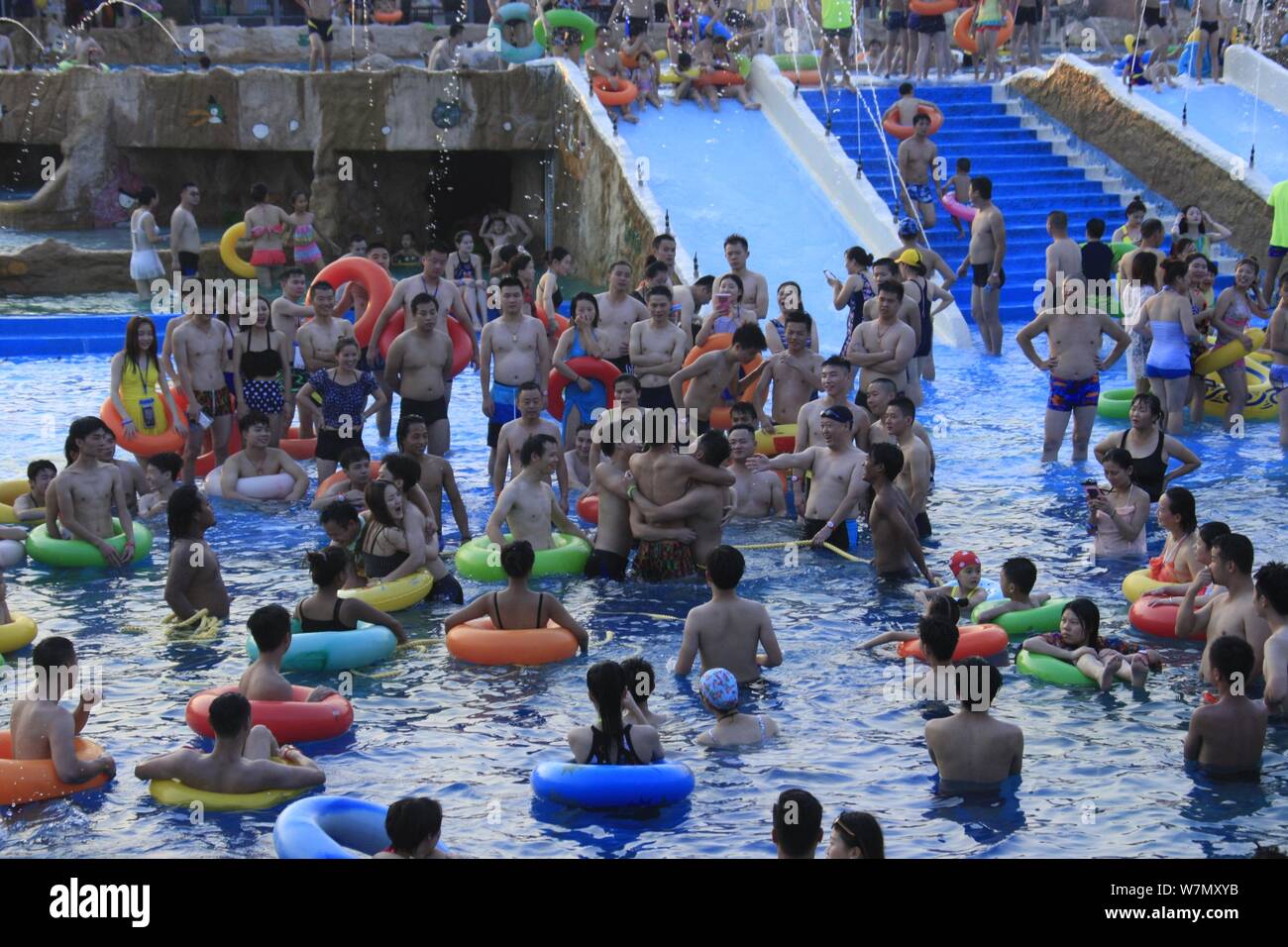 Chinese holidaymakers crowd a swimming pool at a water park in Nanchang ...