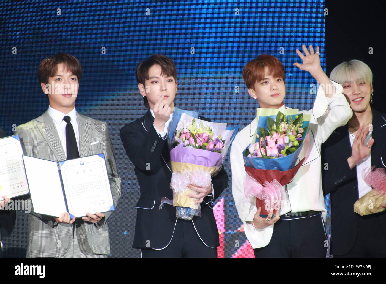 South Korean actor and singer Jung Yong-hwa, left, and members of South ...