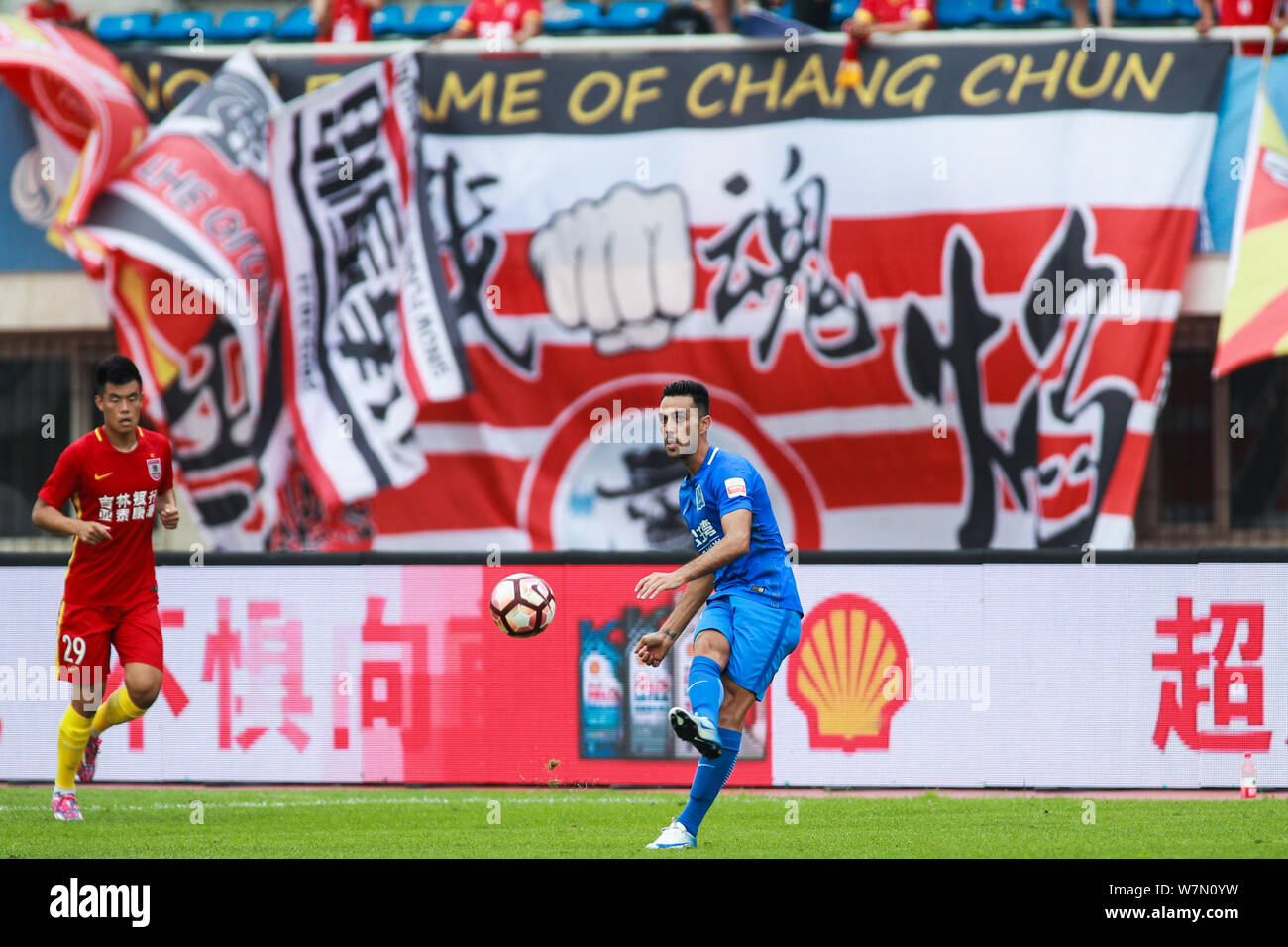 Israeli football player Eran Zahavi, right, of Guangzhou R&F kicks the ...