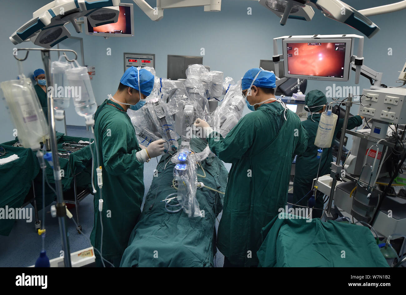 A surgical robot equipped with cameras is carrying out its first ...