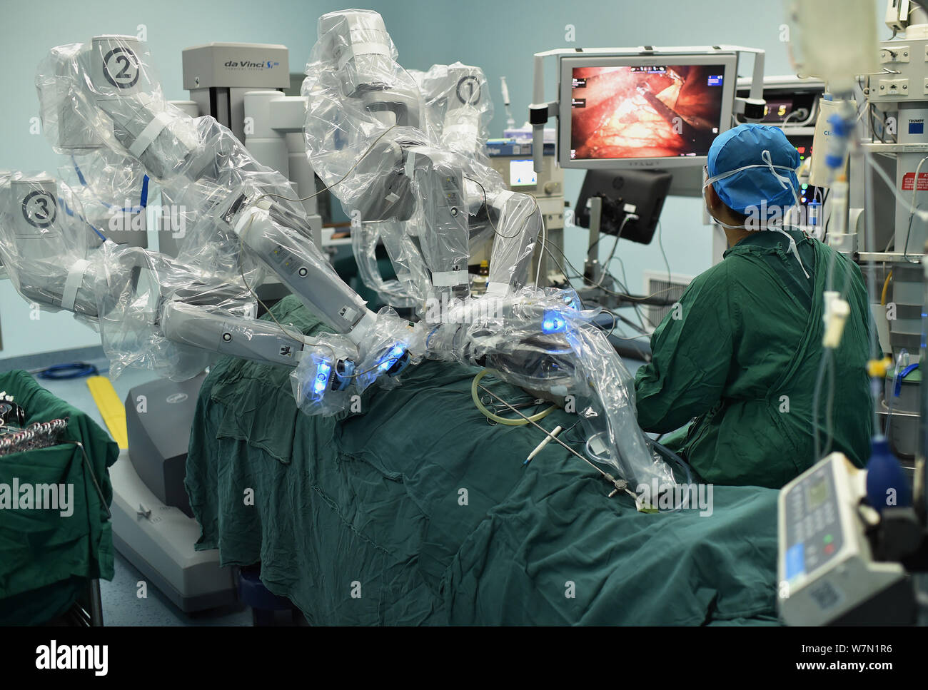 A surgical robot equipped with cameras is carrying out its first ...