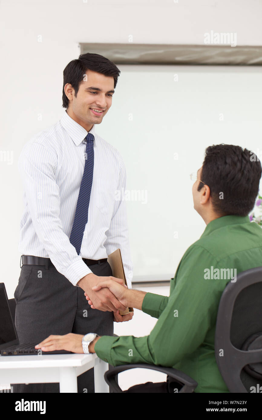 Financial advisor shaking hands with his customer Stock Photo - Alamy