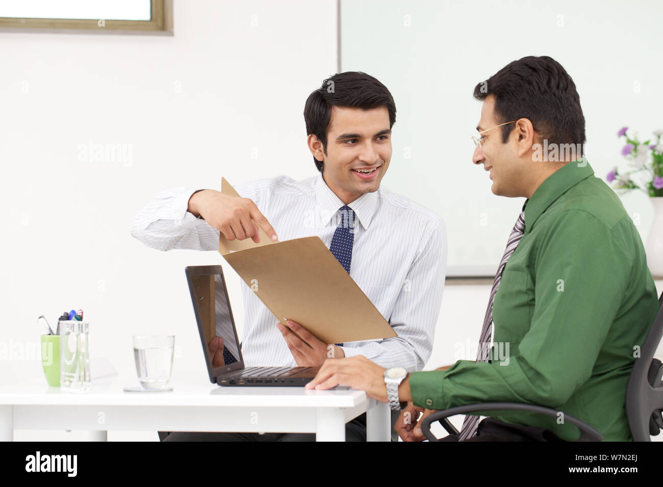 Two business executives discussing in an office Stock Photo - Alamy