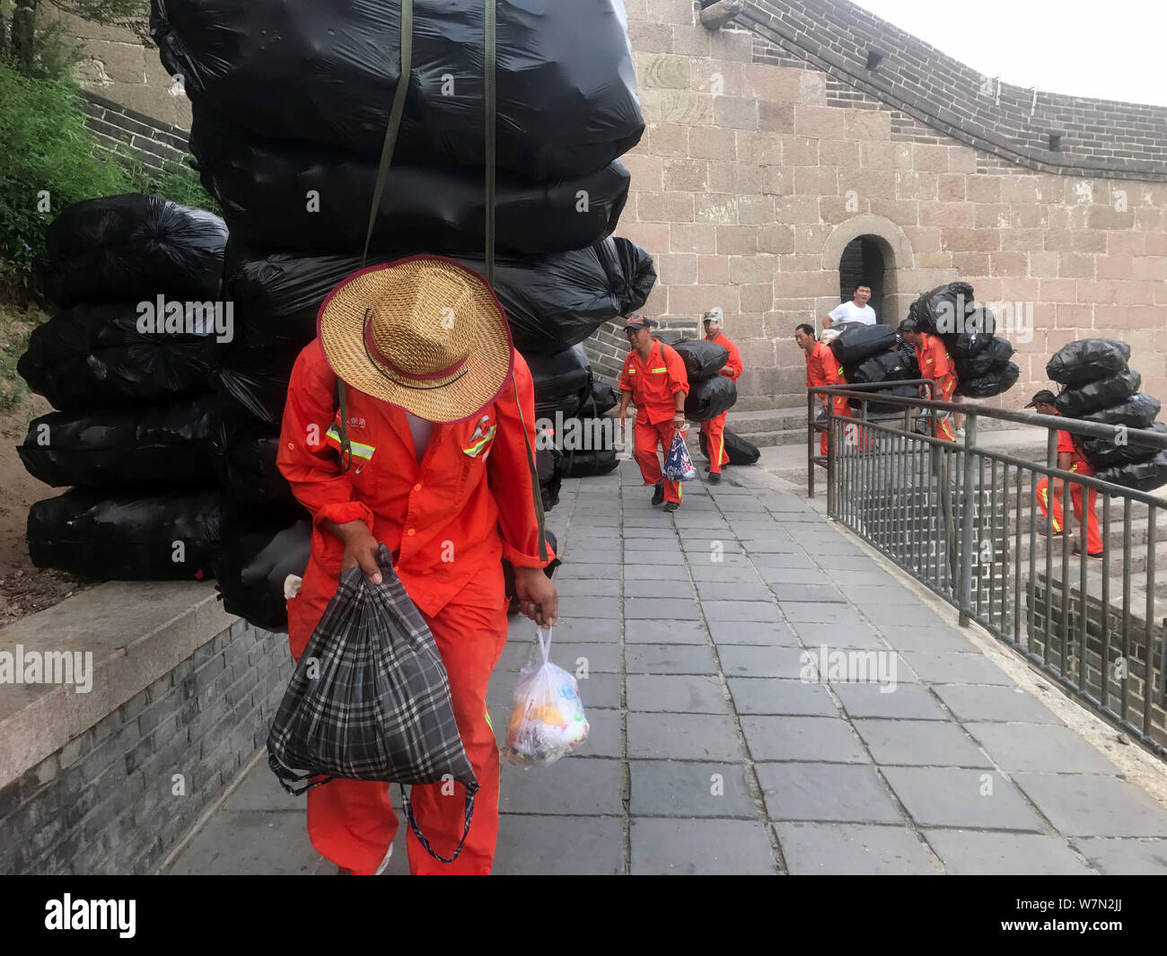 Chinese workers carry a total of 6 tons garbage from the Badaling ...