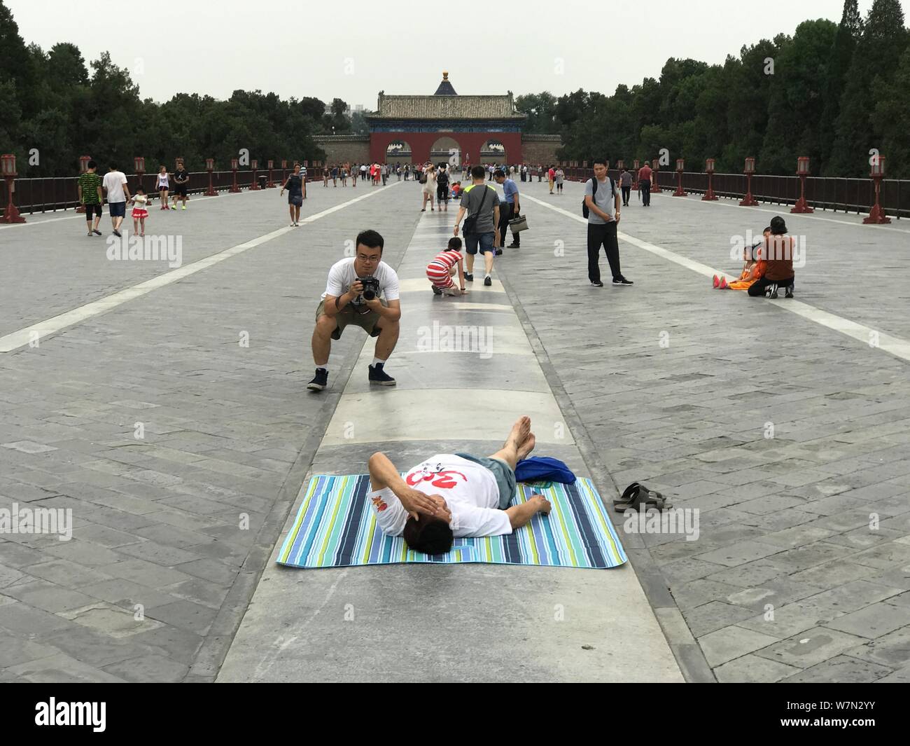 Chinese visitors lie on the Danbi Bridge in the Temple of Heaven Park ...