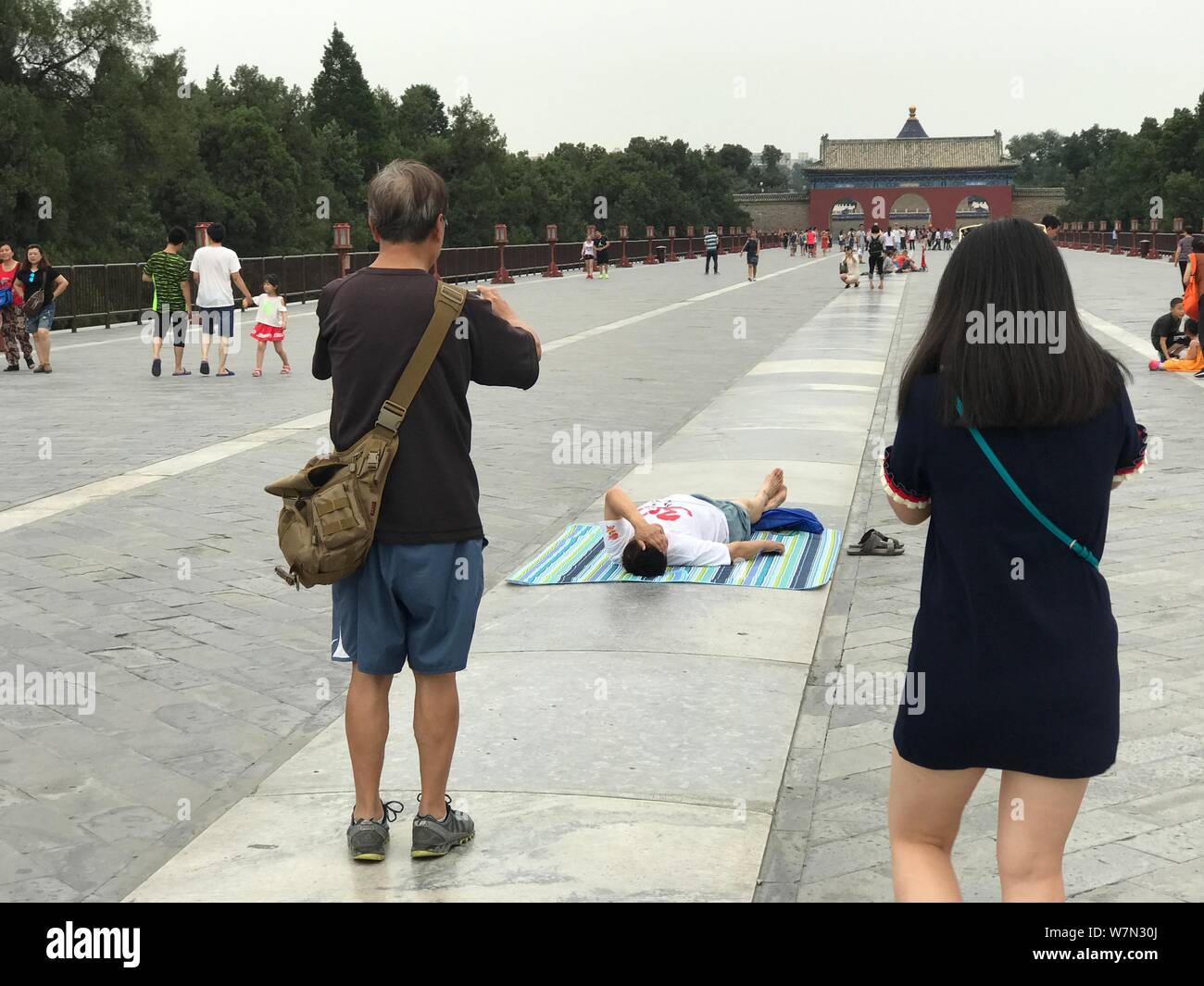 Chinese visitors lie on the Danbi Bridge in the Temple of Heaven Park ...