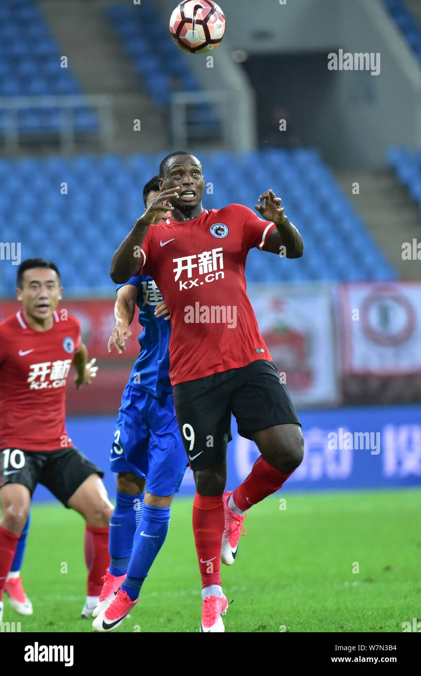 Nigerian football player Anthony Ujah of Liaoning Whowin heads the ball ...