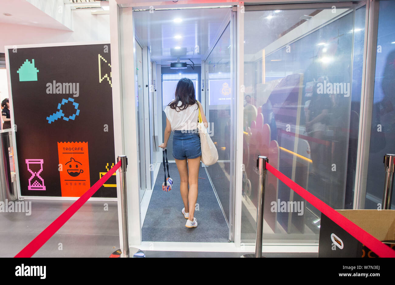 A customer pays her purchase as she walks through a door that can ...