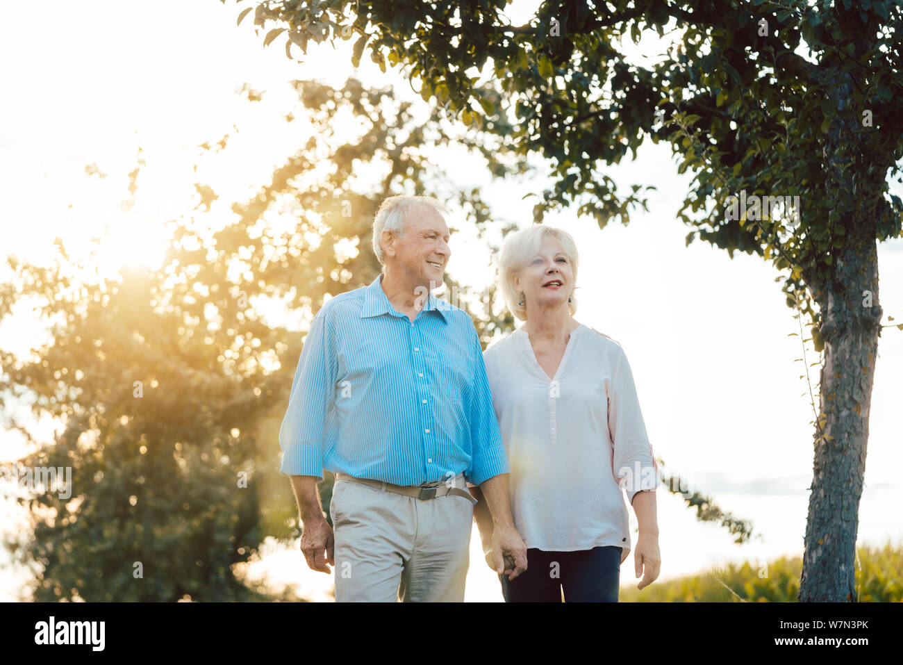 Senior woman and man having a walk along path in the countryside Stock ...