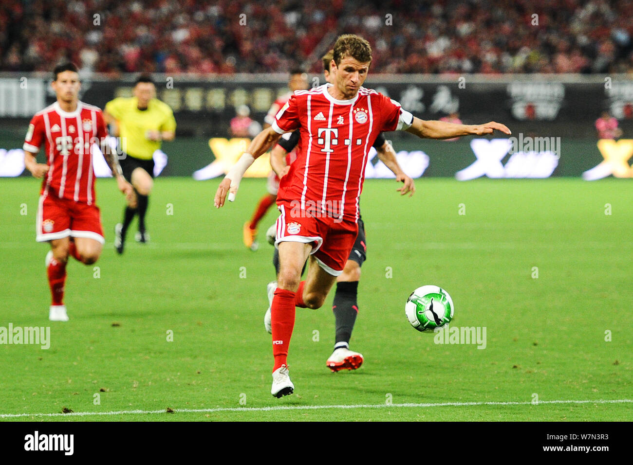 German football player Thomas Muller of Bayern Munich kicks the ball to ...