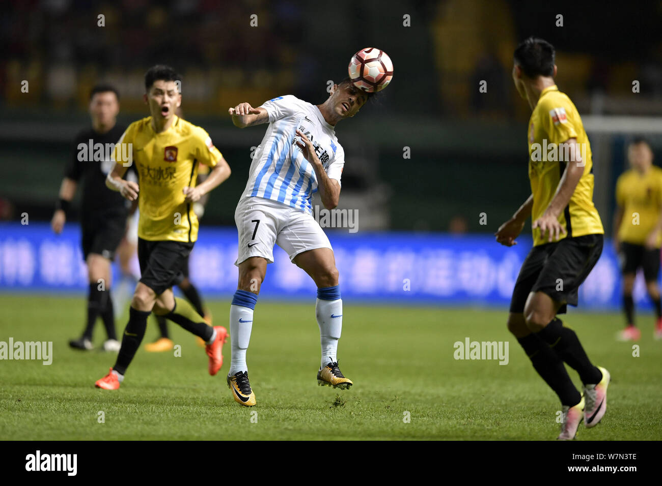 Israeli football player Eran Zahavi, center, of Guangzhou R&F heads the ...