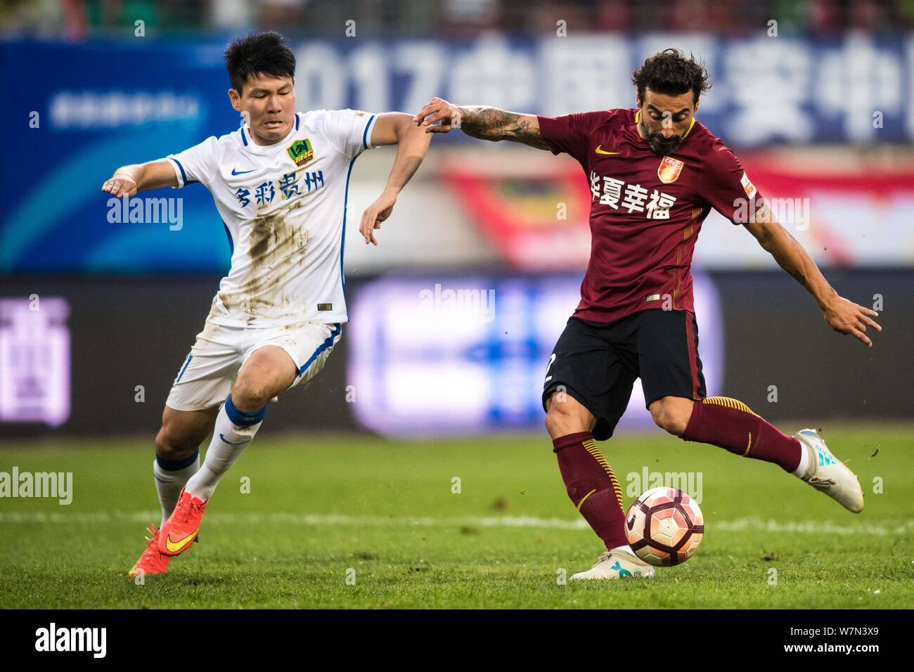 Argentine football player Ezequiel Lavezzi, right, of Hebei China ...