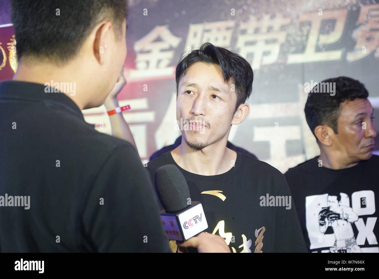 Chinese boxing star Zou Shiming is interviewed at a weighing ceremony ...