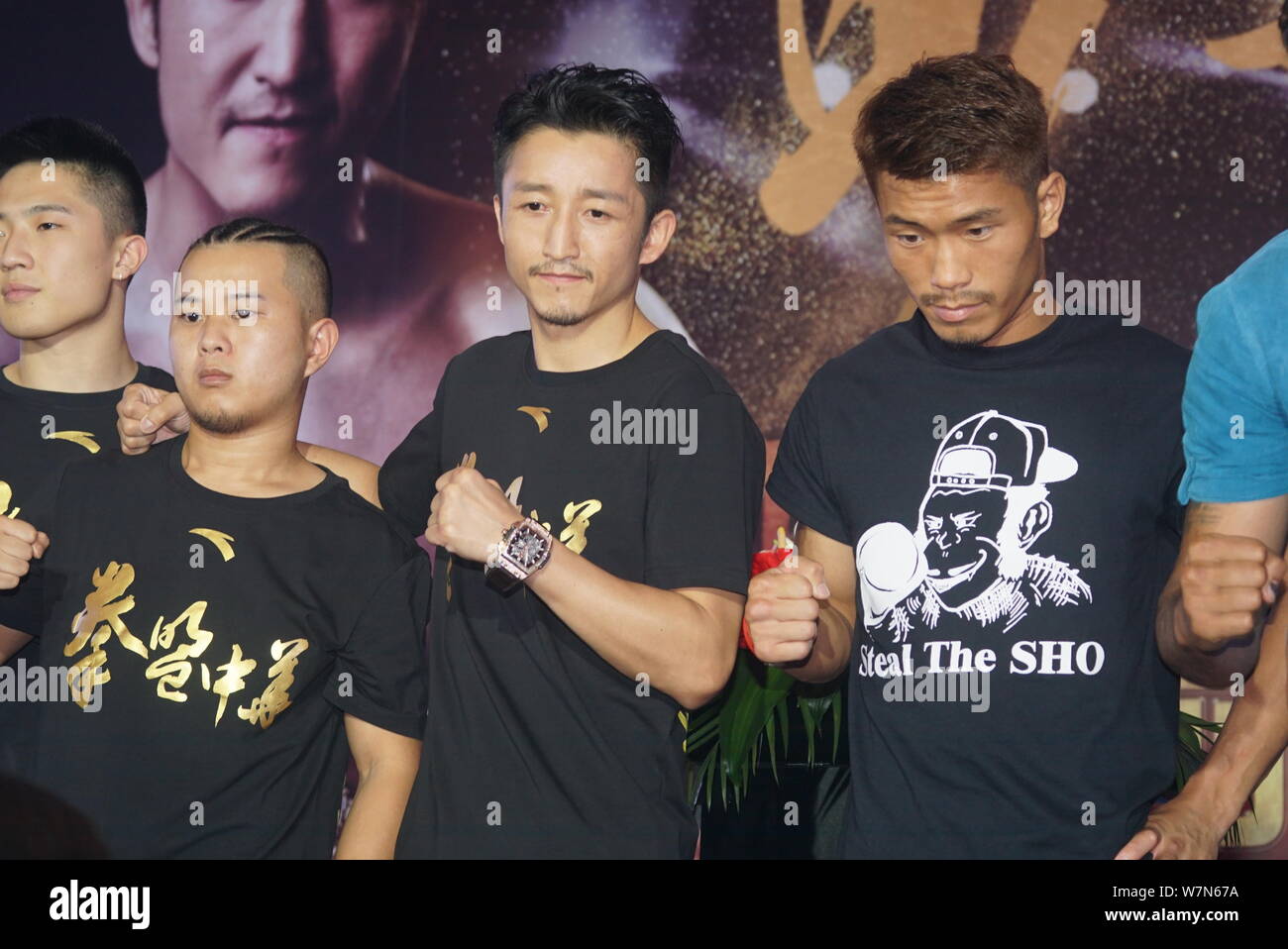 Chinese boxing star Zou Shiming, center, and Japanese boxer Sho Kimura ...