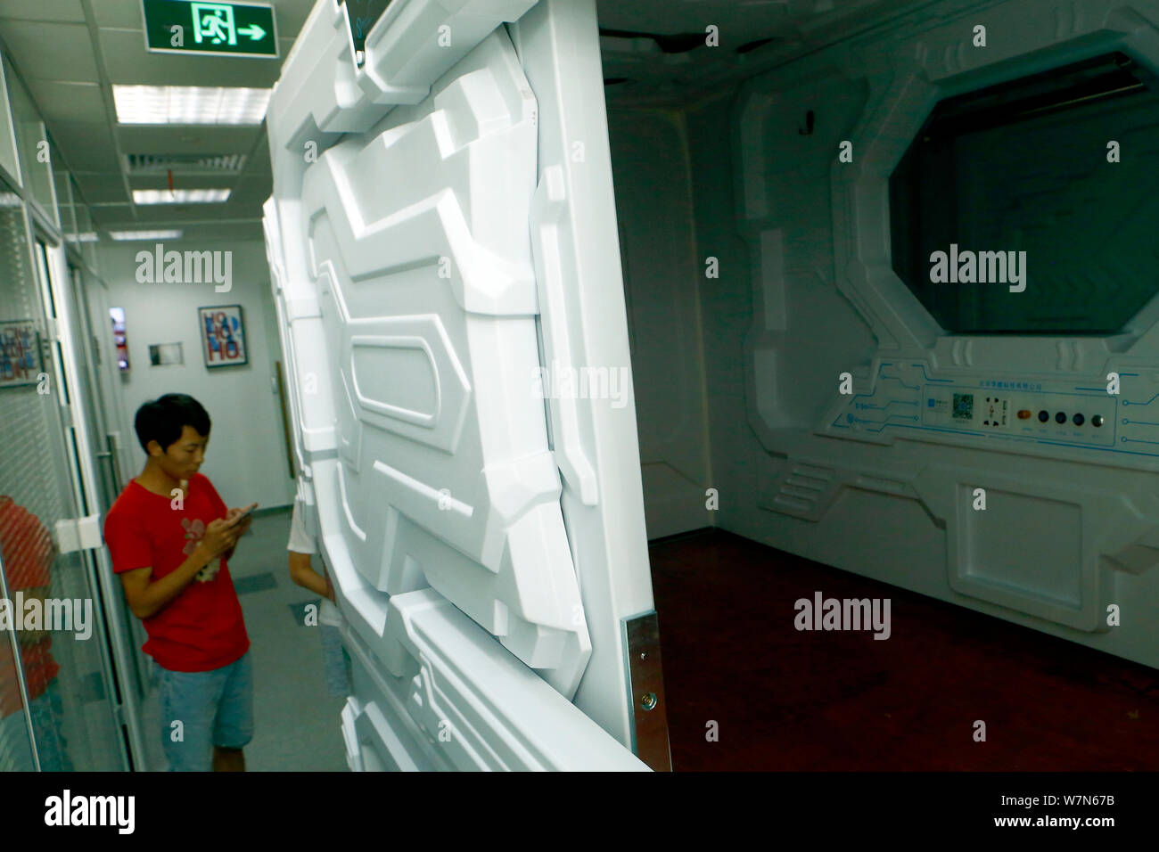 A Chinese employee takes photos of a temporarily closed "sleep-sharing ...