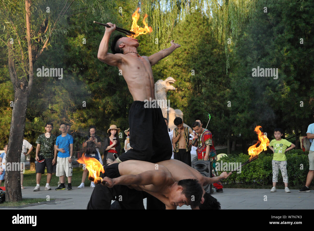 Chinese artists perform for tourists with fire on Toufu, the first ...