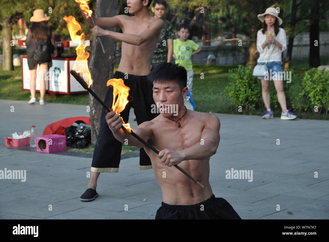 Chinese artists perform for tourists with fire on Toufu, the first ...