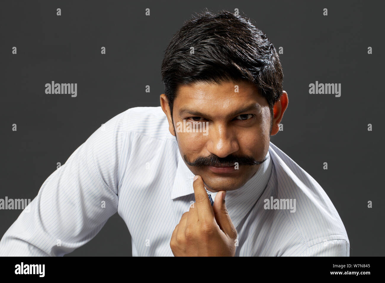 Hand on chin businessman hi-res stock photography and images - Alamy