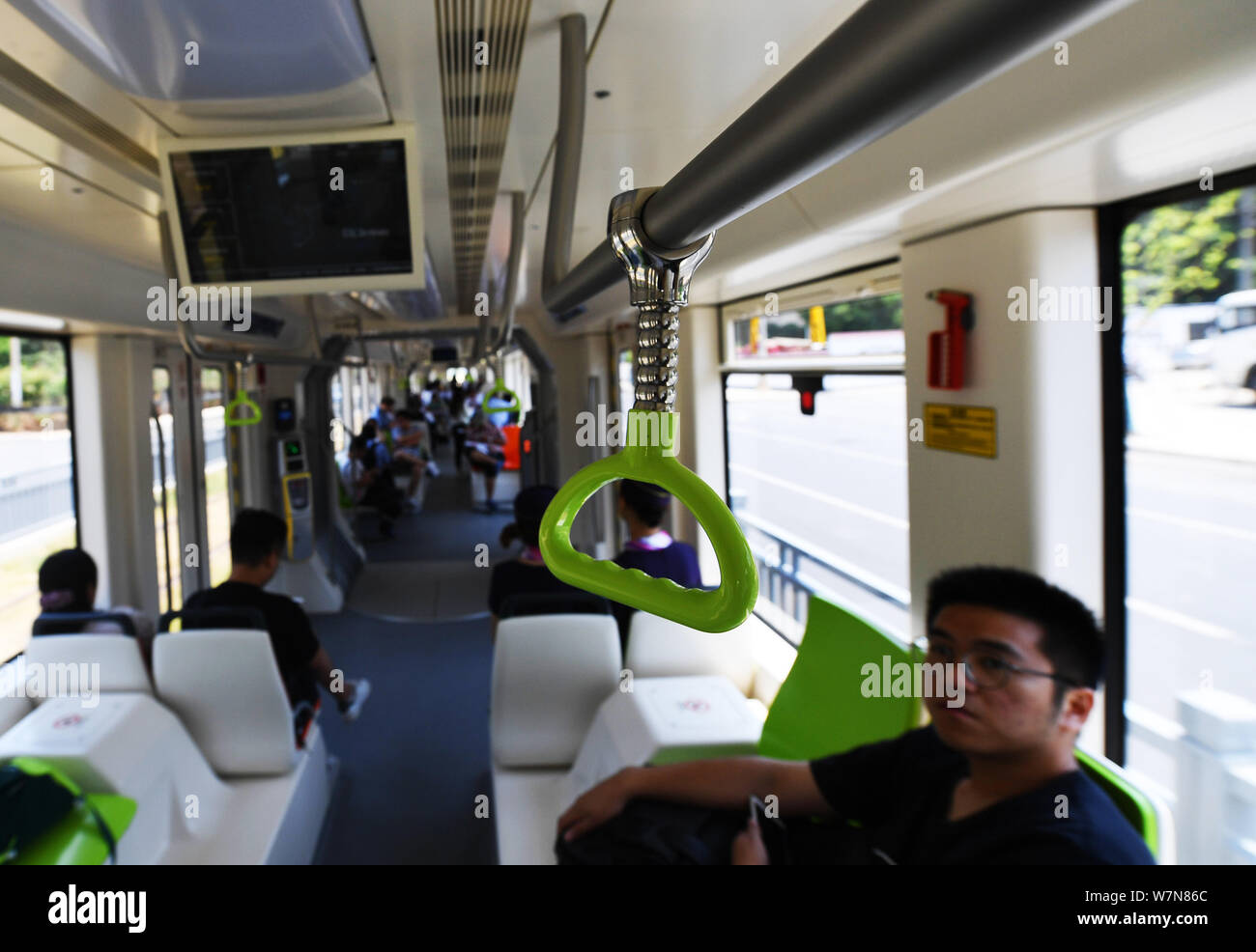 Passengers are seen in a tramcar on the city's first tram line in Wuhan ...