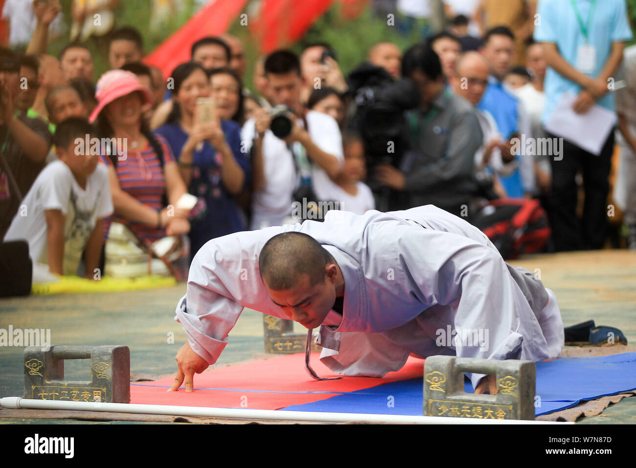 A competitor does a push-up to support himself by his index fingers and ...