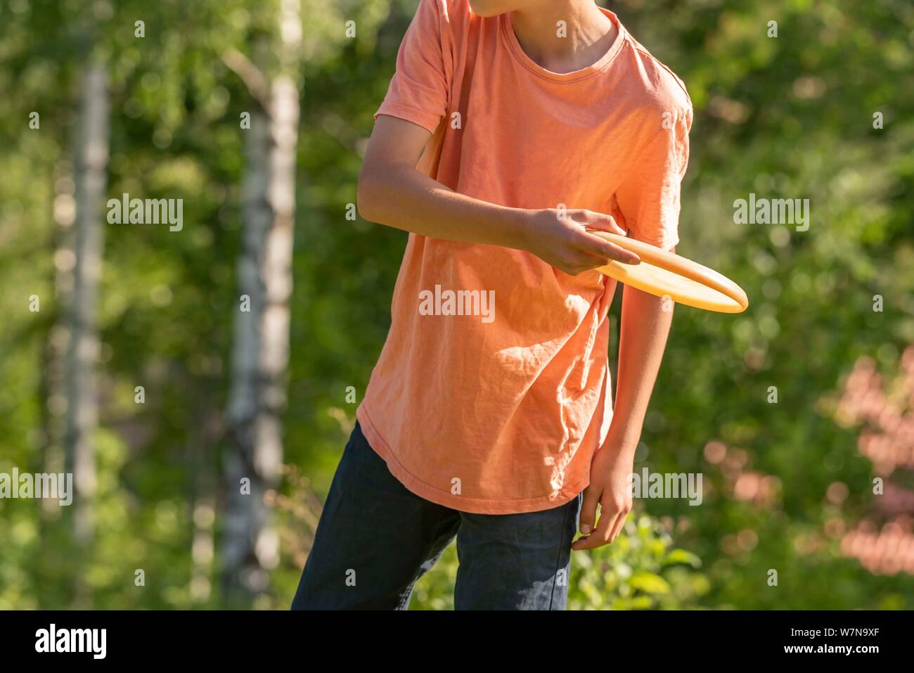 Boy throwing flying disc in summer Stock Photo - Alamy
